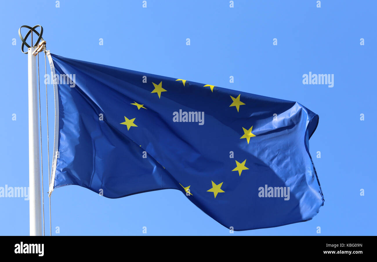european flag with yellow stars and blue sky on background Stock Photo ...