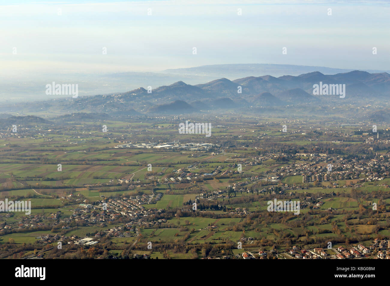 aerial view of plain with countries and mountains with a little mist ...
