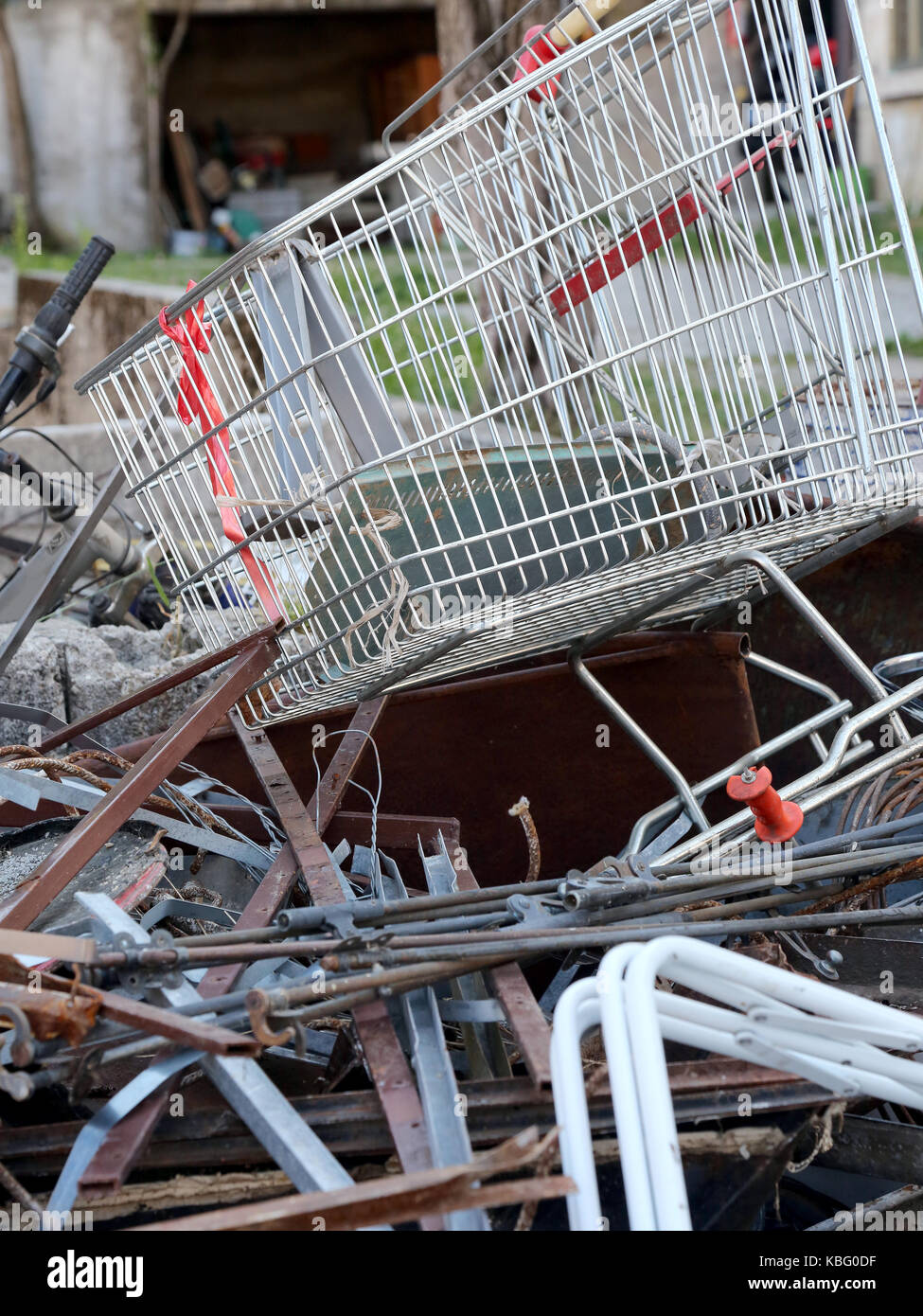 rusty old shopping cart in recycling of ferrous material for disposal ...