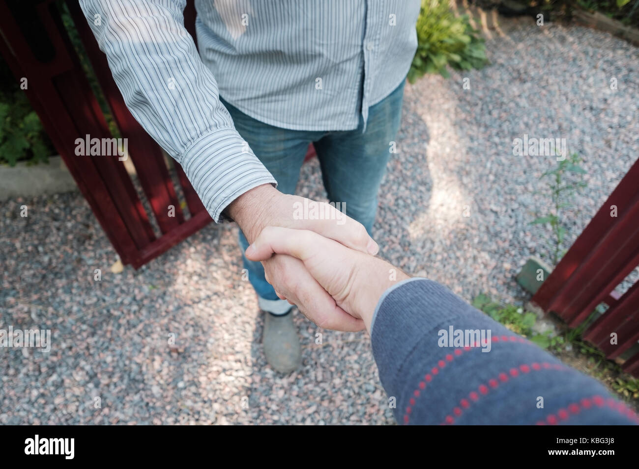 Top view of two men shaking hands while standing outdoor Stock Photo ...