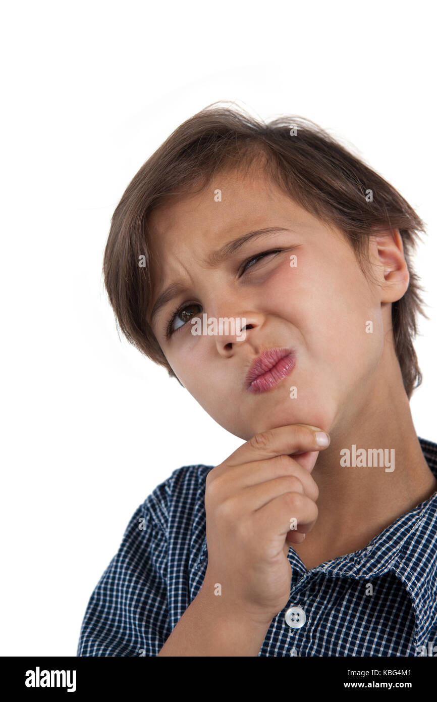 Thoughtful boy standing against white background Stock Photo - Alamy