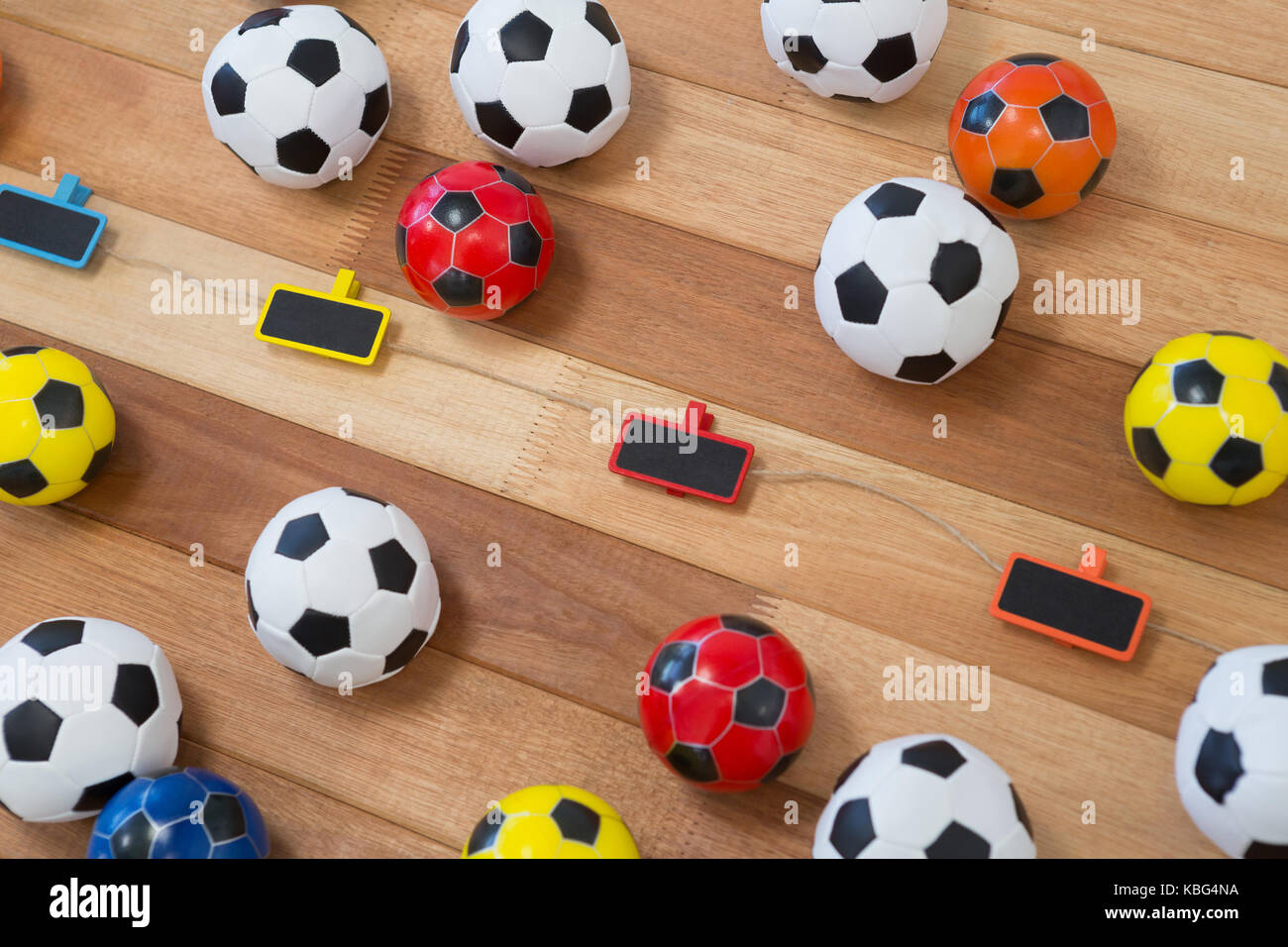Overhead of colorful footballs on wooden table Stock Photo - Alamy