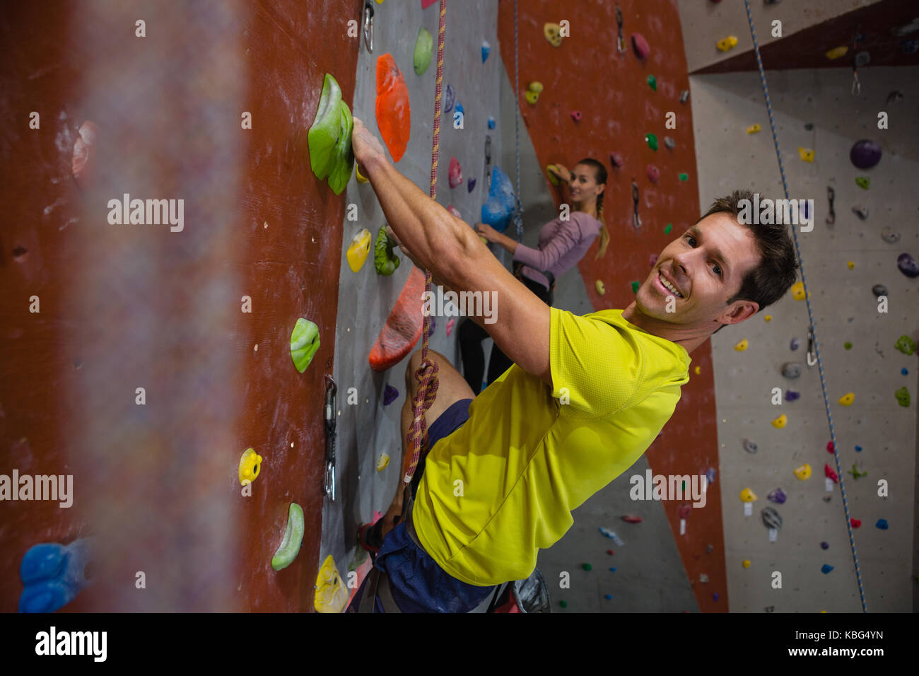 Smiling athlete climbing wall hi-res stock photography and images - Alamy