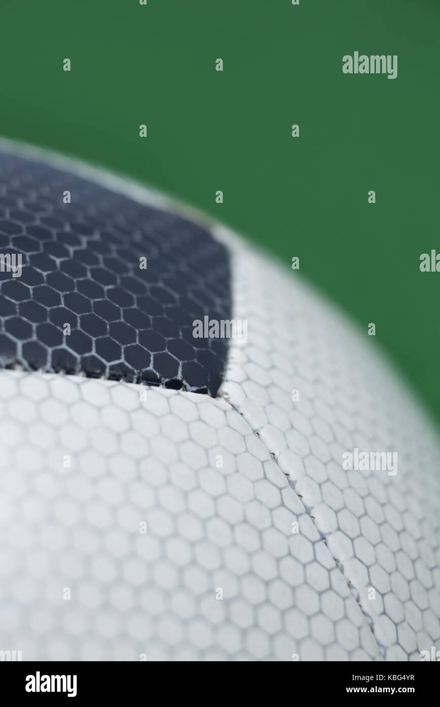 Close-up of football against green background Stock Photo - Alamy