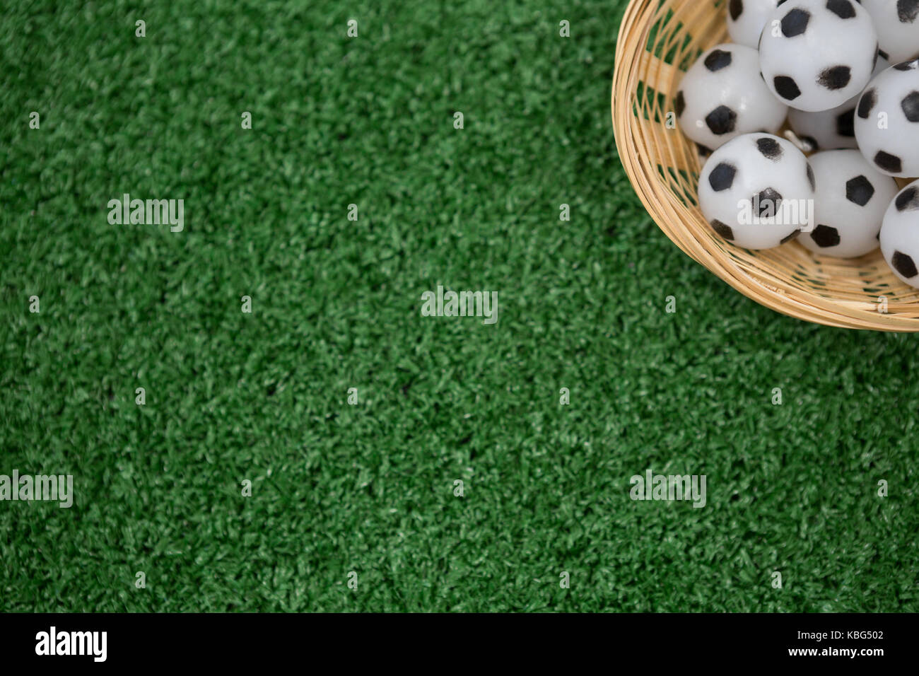 Overhead view of footballs in wicker basket on artificial grass Stock ...