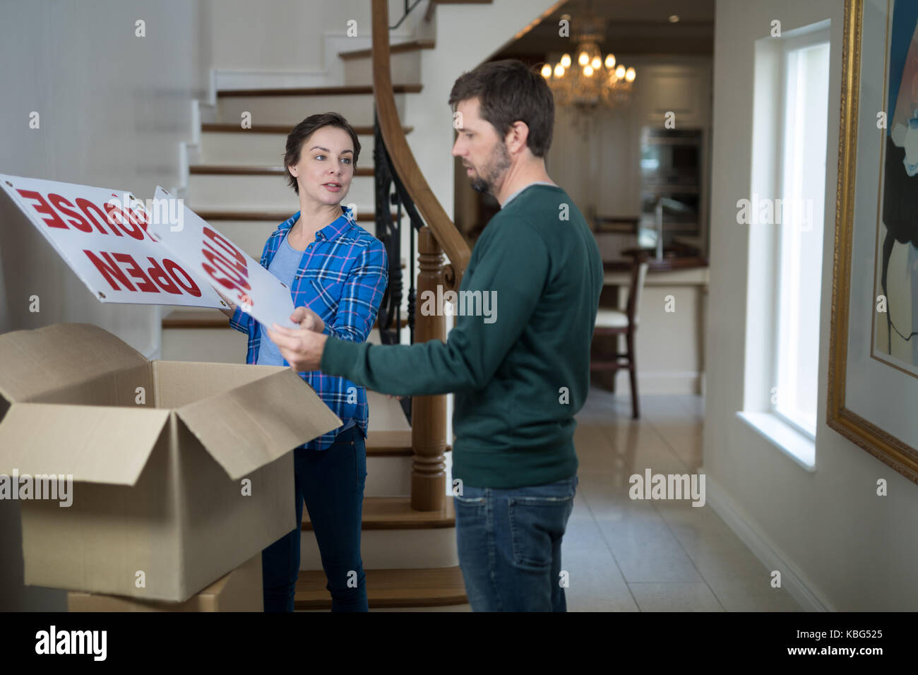 Couple opening cardboard boxes in living room at home Stock Photo - Alamy