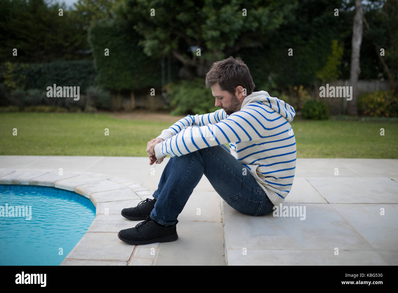 Man standing near swimming pool hi-res stock photography and images - Alamy