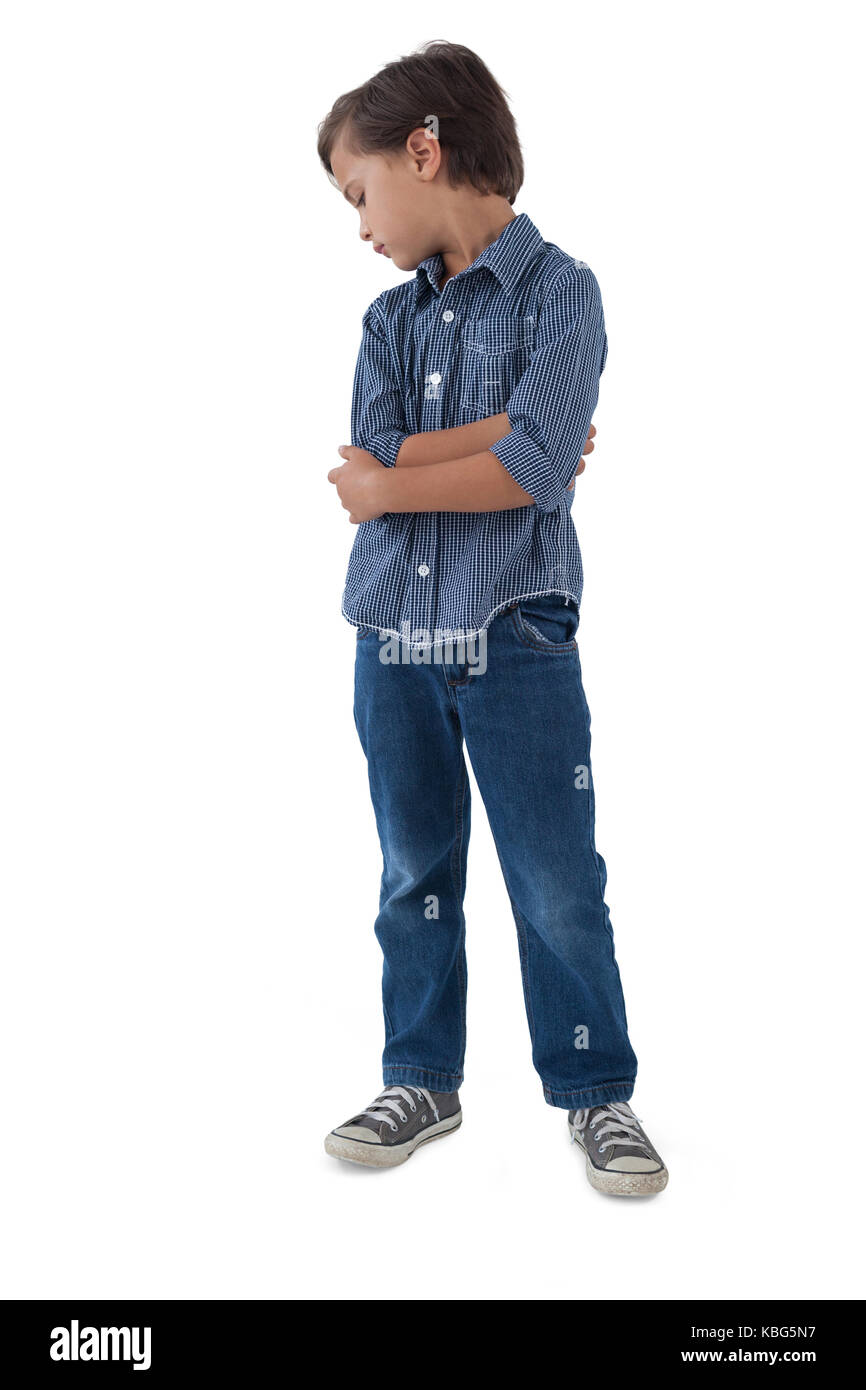 Thoughtful boy standing against white background Stock Photo - Alamy
