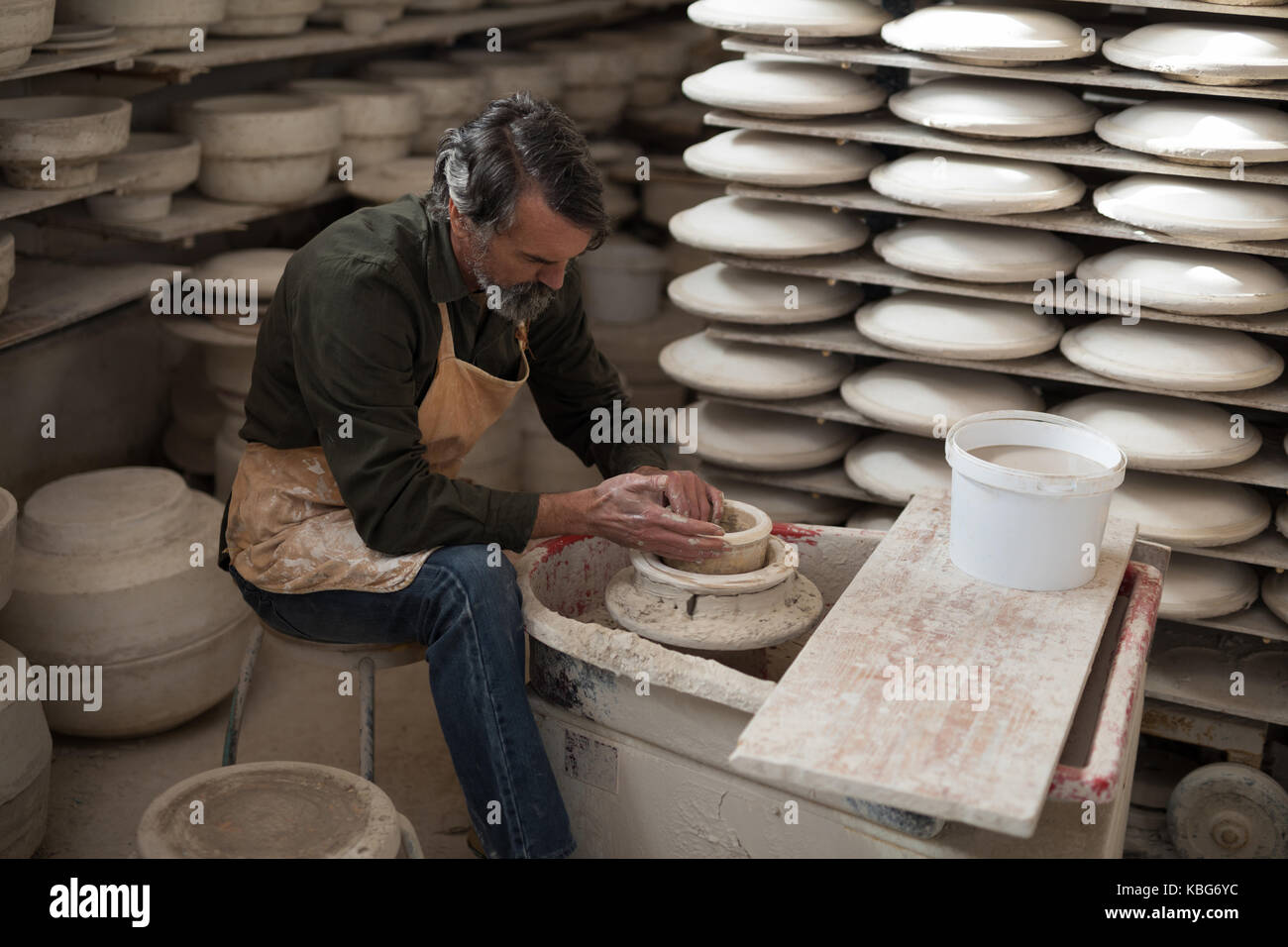Male potter molding a clay in pottery workshop Stock Photo - Alamy
