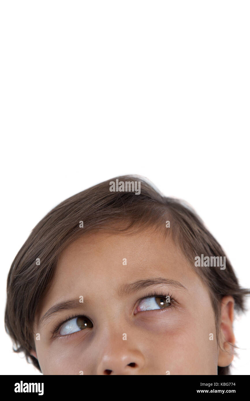 Thoughtful boy standing against white background Stock Photo - Alamy