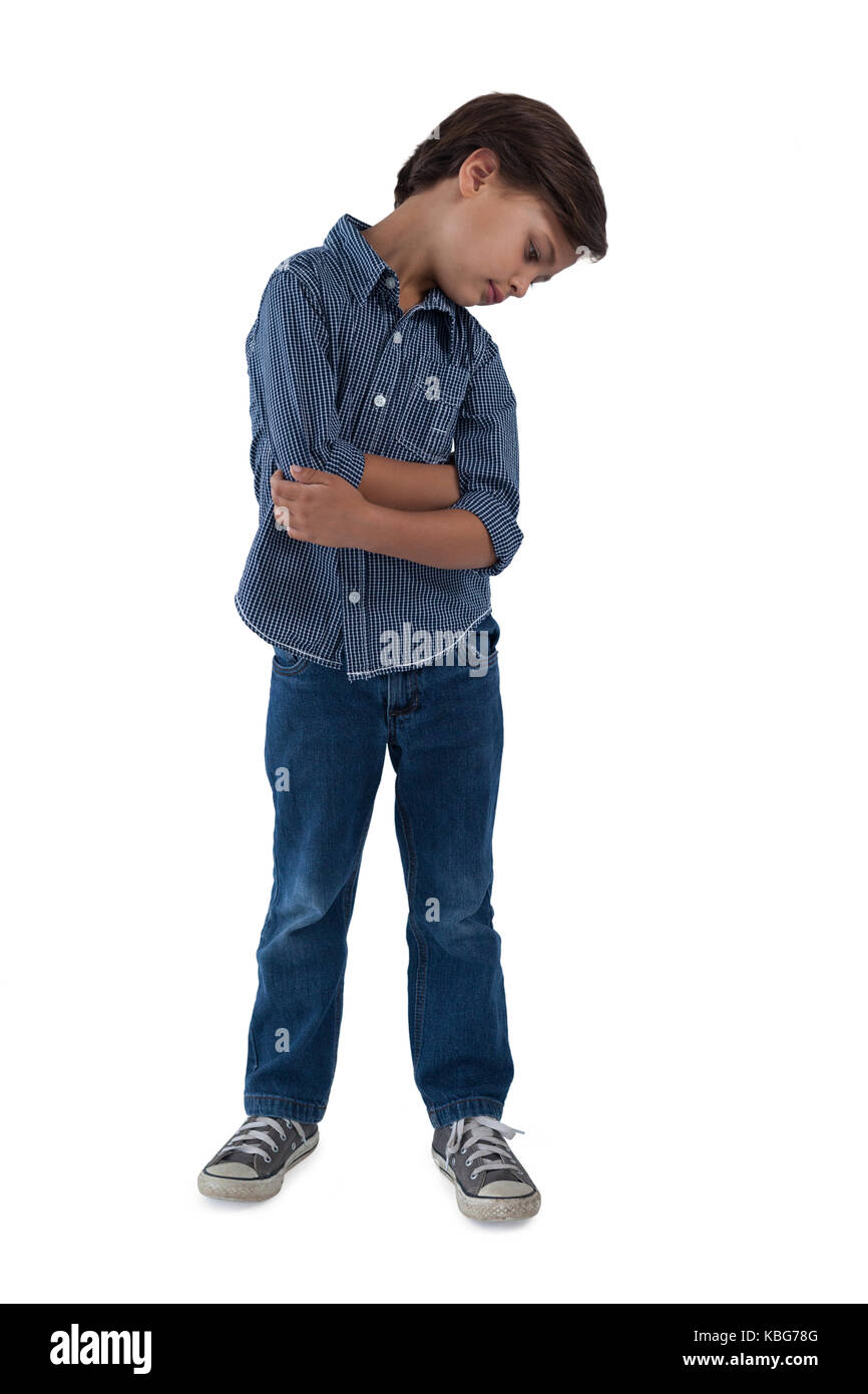 Thoughtful boy standing against white background Stock Photo - Alamy