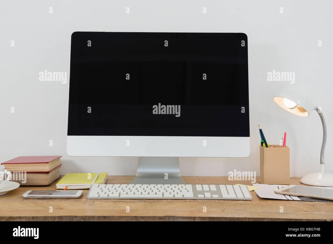 Desktop pc and various office accessories on table in office Stock ...