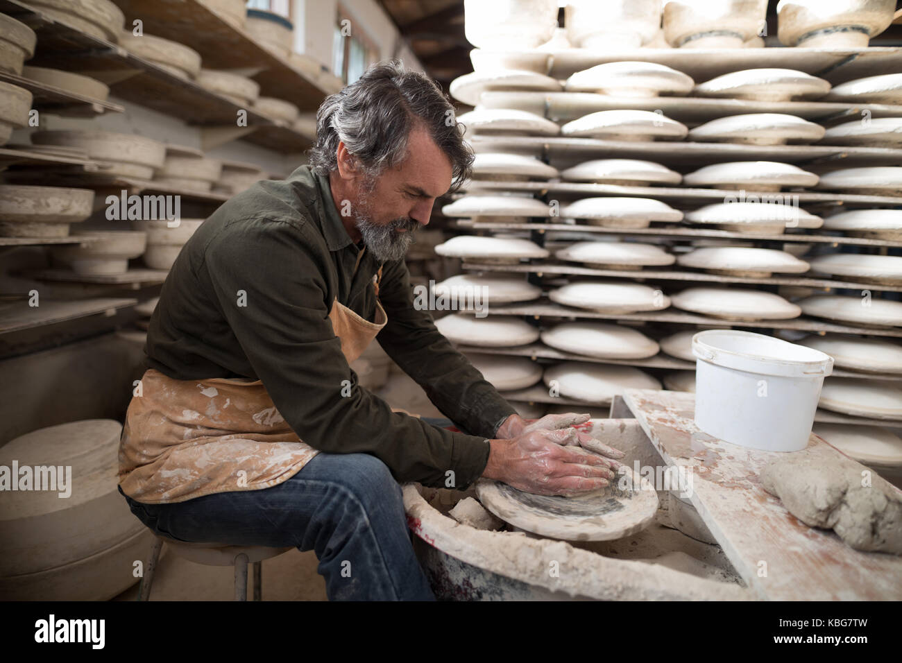 Male potter molding a clay in pottery workshop Stock Photo - Alamy