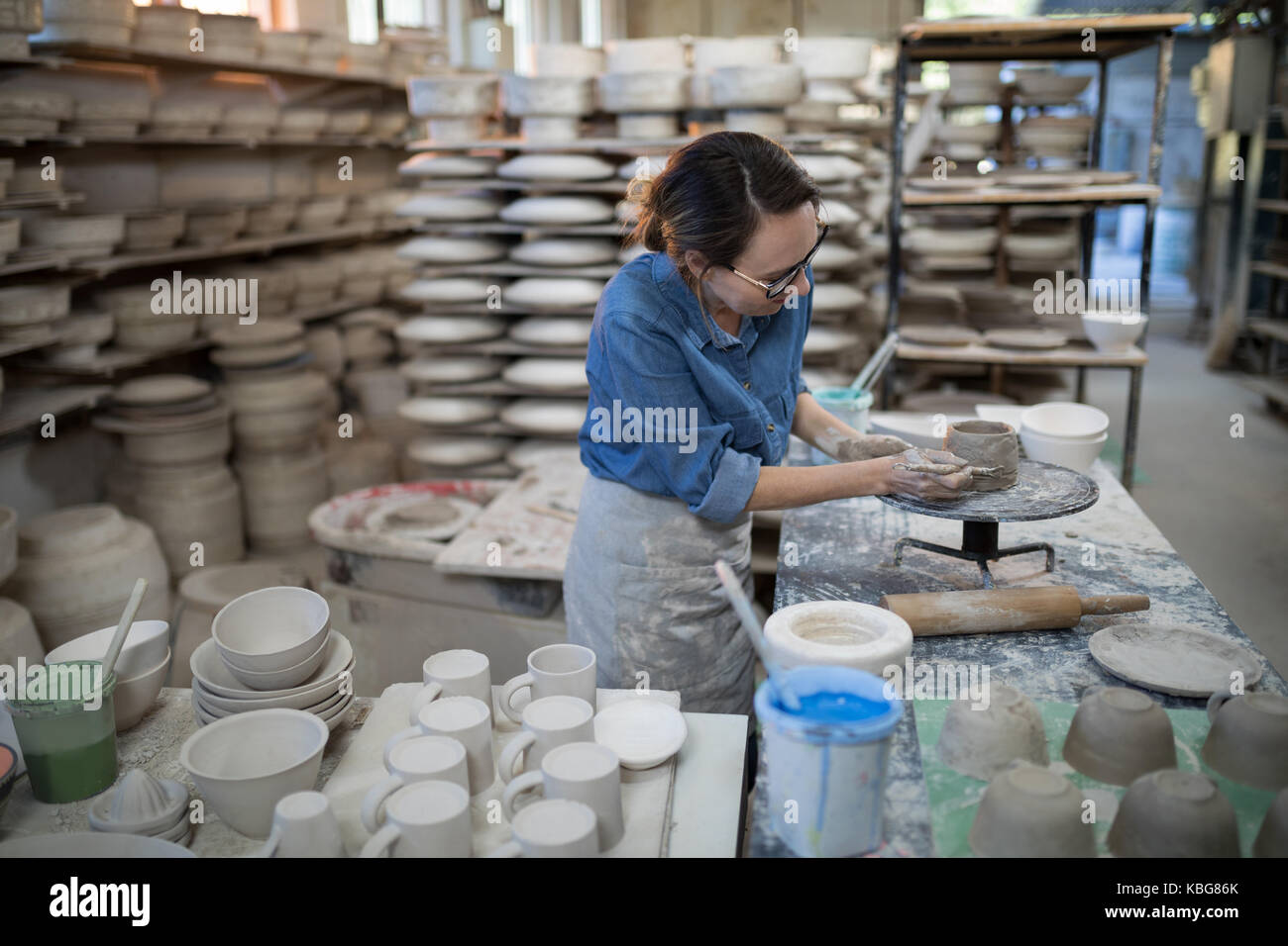 Female potter molding a clay in pottery workshop Stock Photo - Alamy
