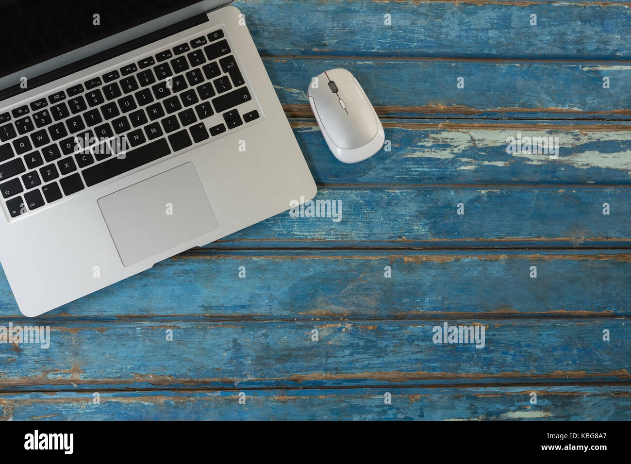 Overhead of laptop and mouse on wooden table Stock Photo - Alamy