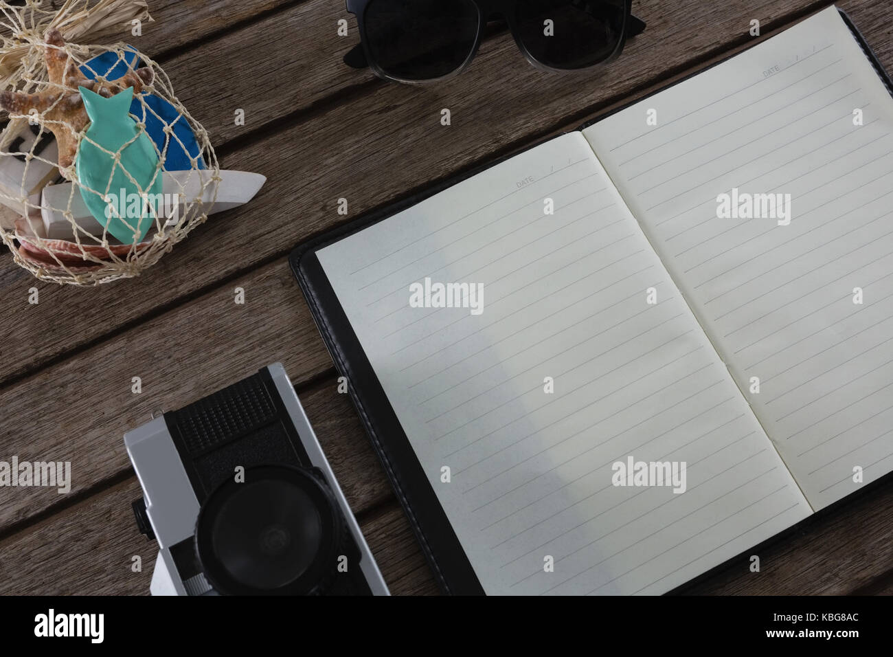 Close-up of open diary surrounded with travelling accessories Stock ...