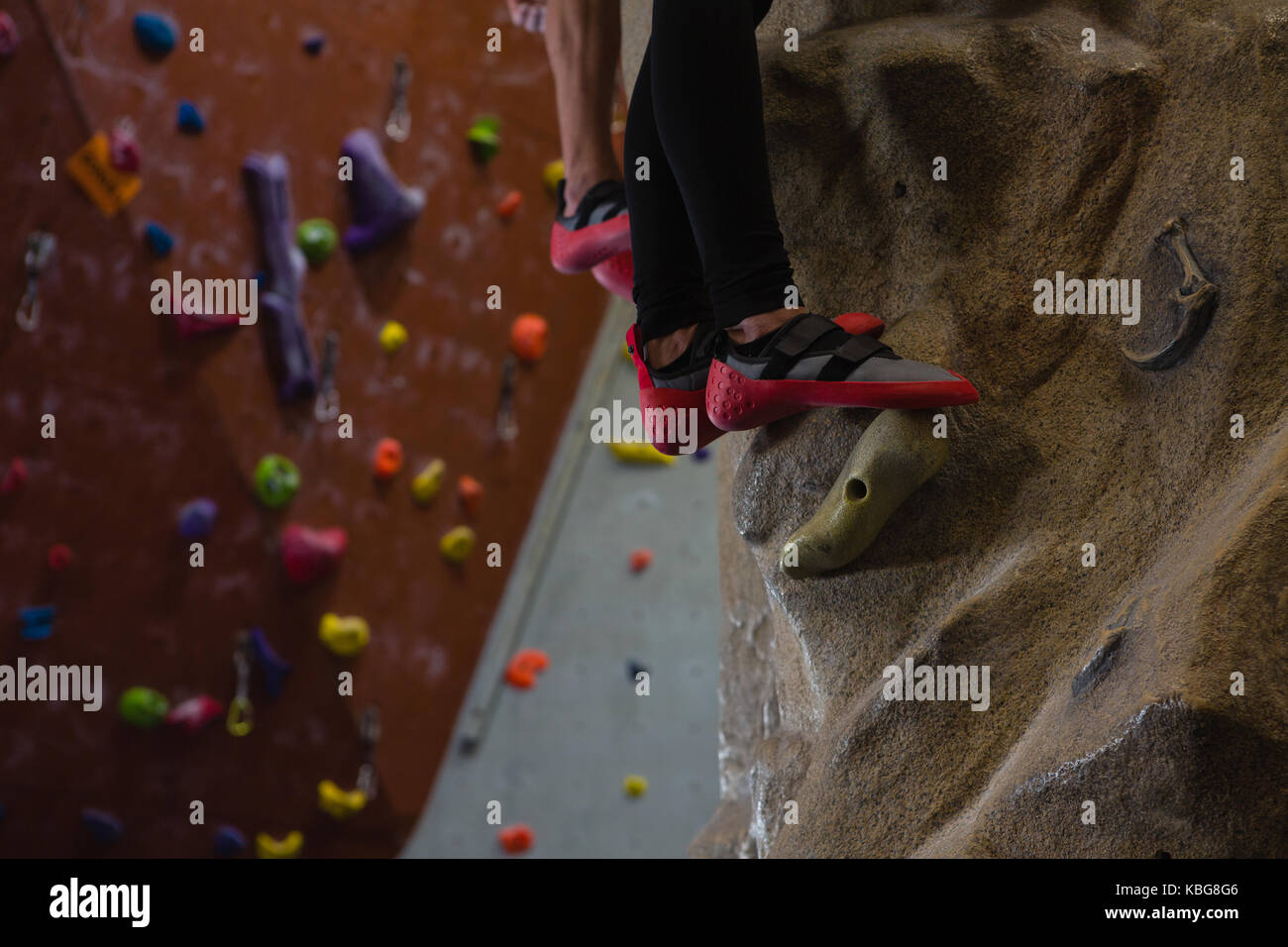 Low section of athletes rock climbing at fitness studio Stock Photo - Alamy