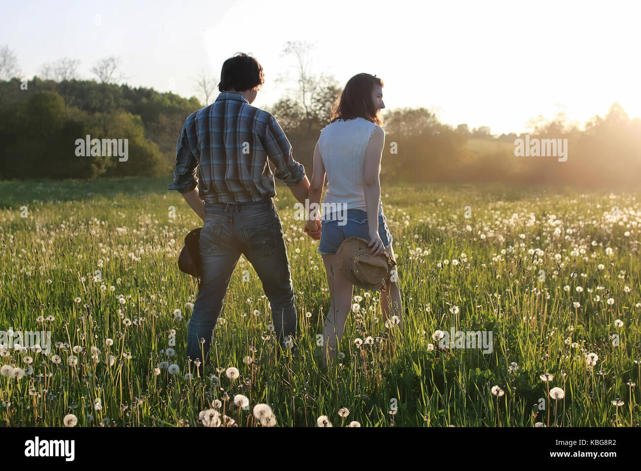 couple of young people walking in the sunset spring evening in a Stock ...
