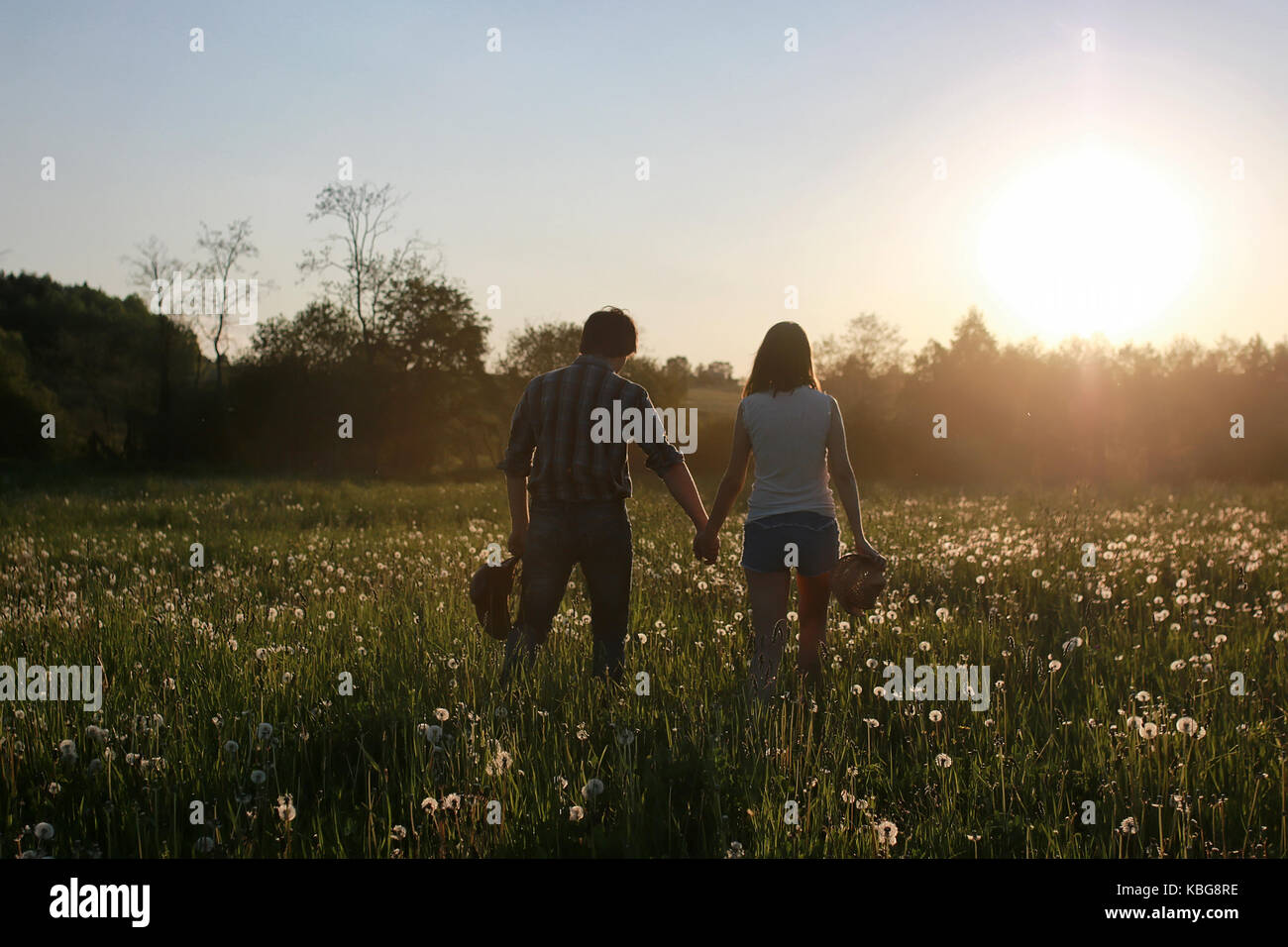 couple of young people walking in the sunset spring evening in a Stock ...