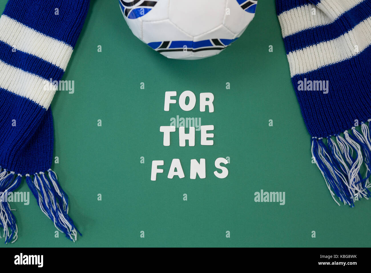 Close-up of muffler and football with text on green background Stock ...