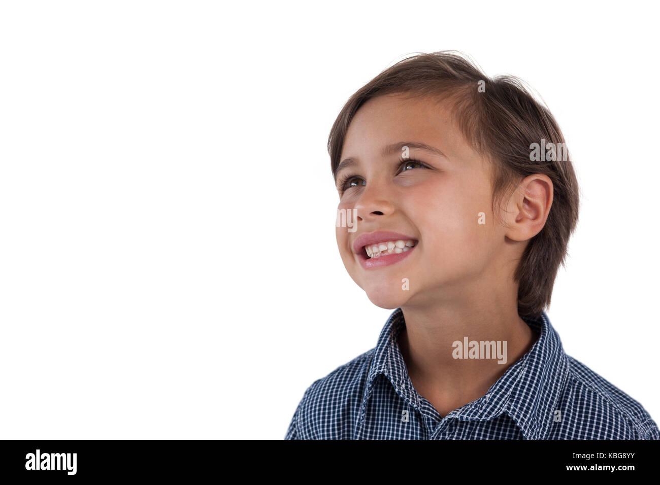 Thoughtful boy standing against white background Stock Photo - Alamy