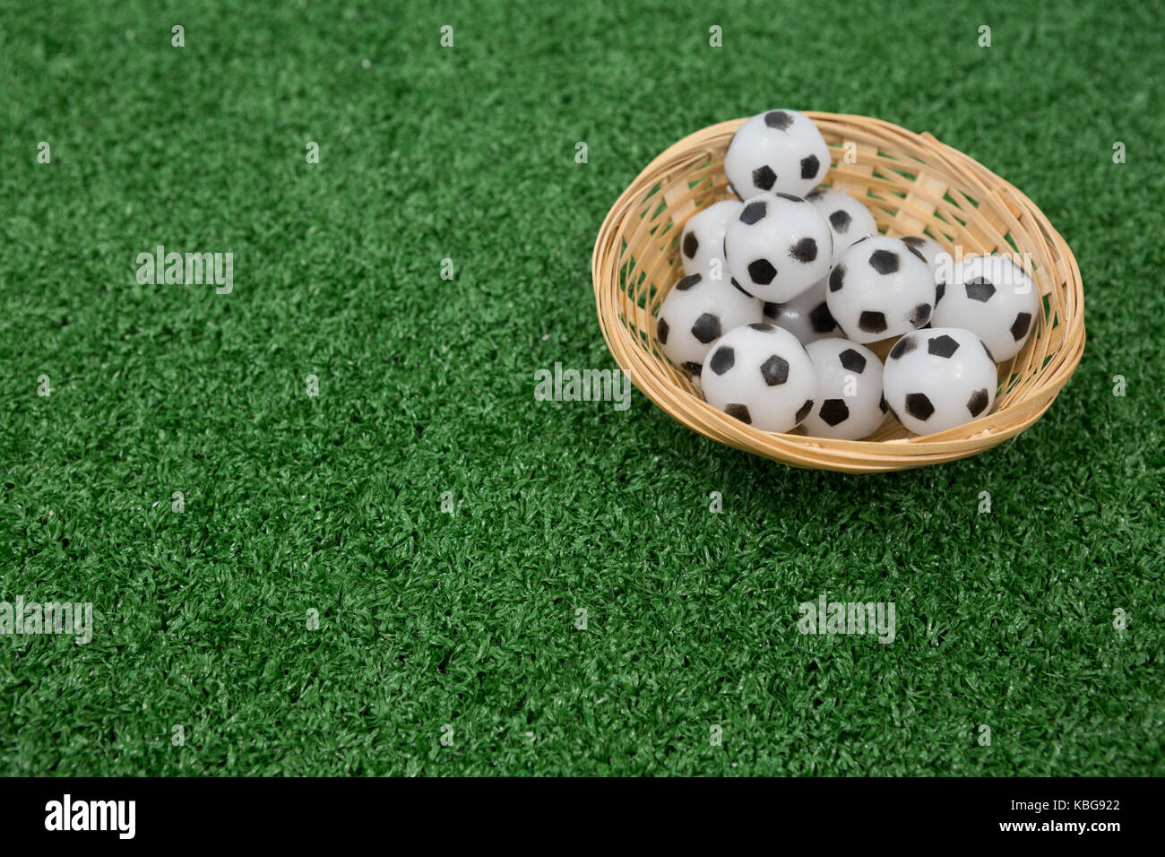 Footballs in wicker basket on artificial grass Stock Photo - Alamy