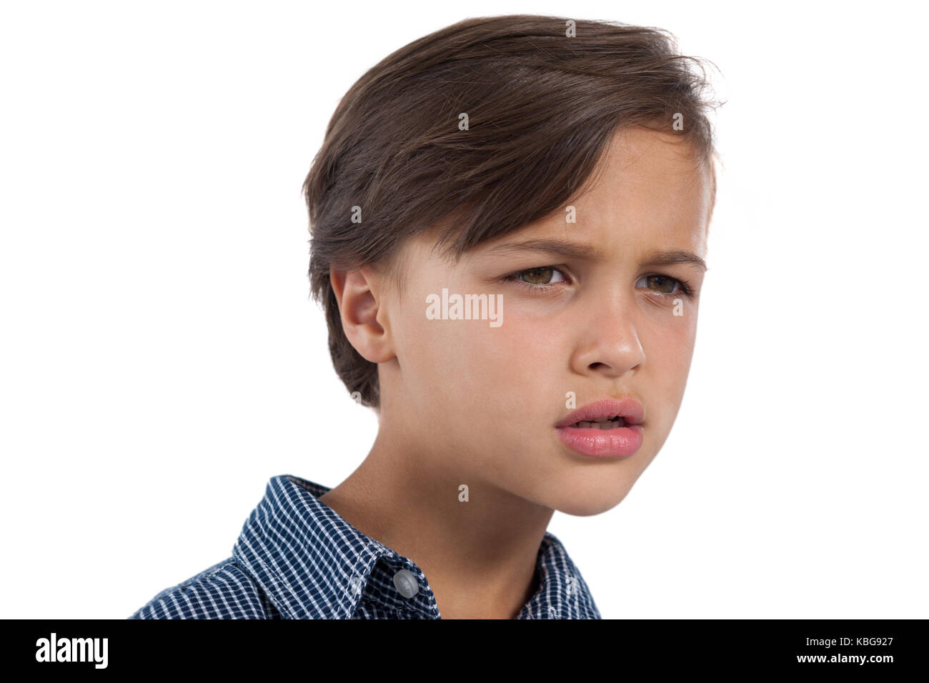 Thoughtful boy standing against white background Stock Photo - Alamy