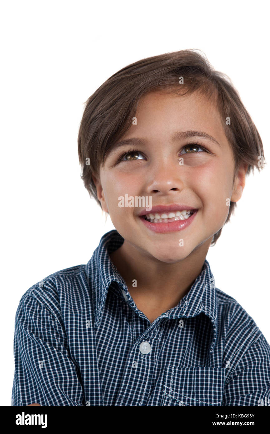 Thoughtful boy standing against white background Stock Photo - Alamy