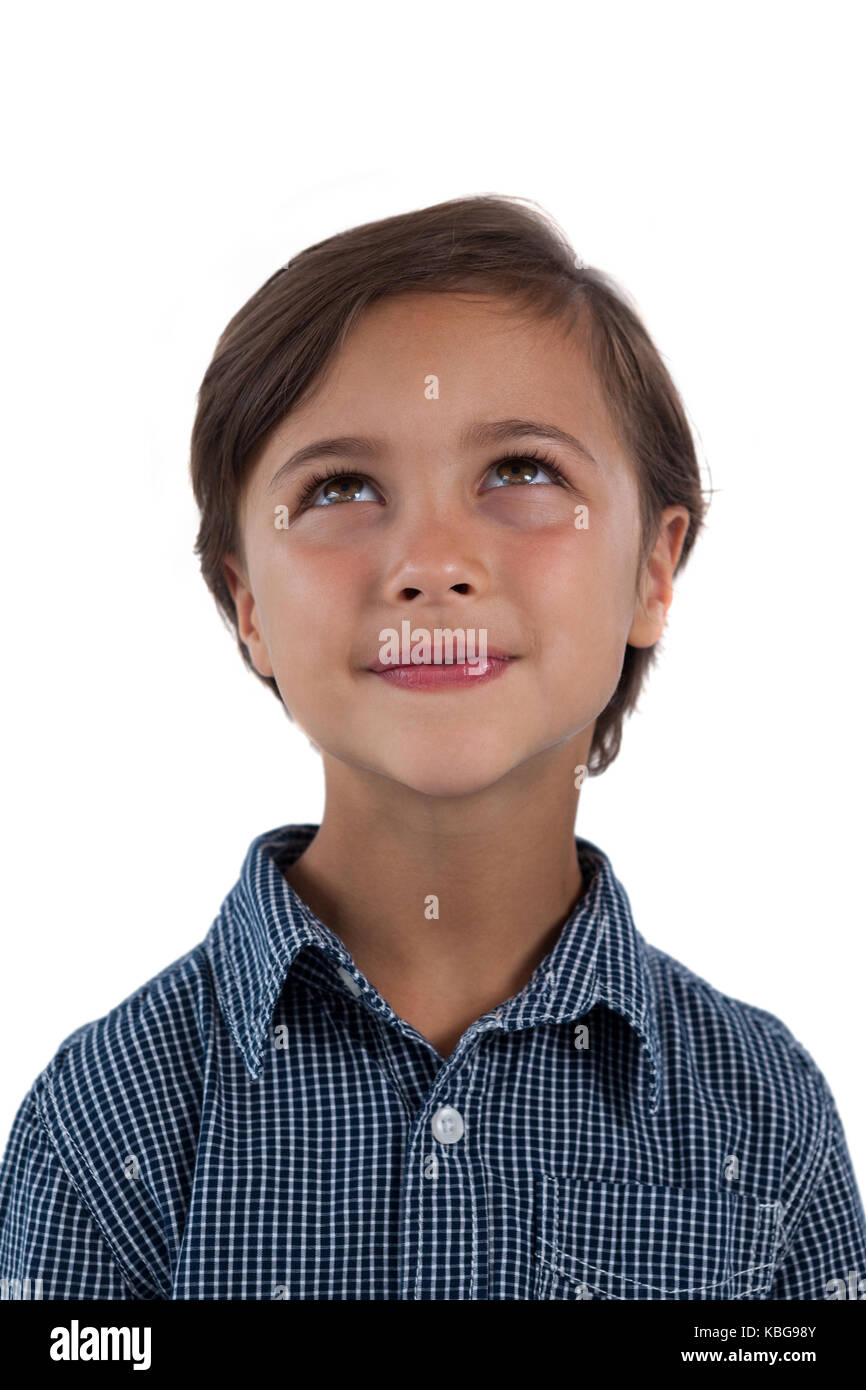 Thoughtful boy standing against white background Stock Photo - Alamy