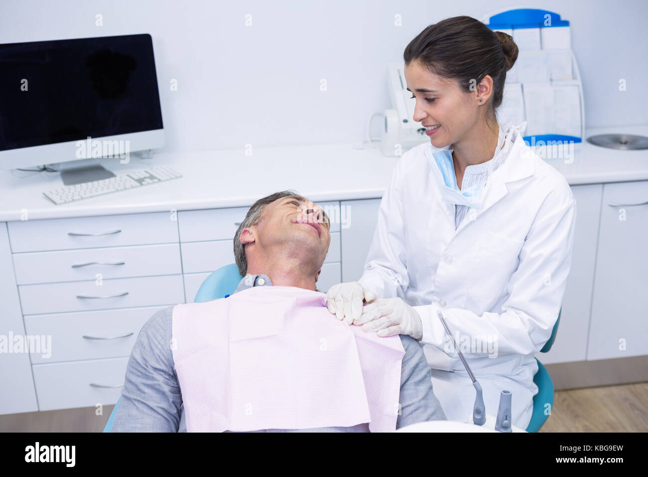 Man taking with doctor while lying on chair at medical clinic Stock ...