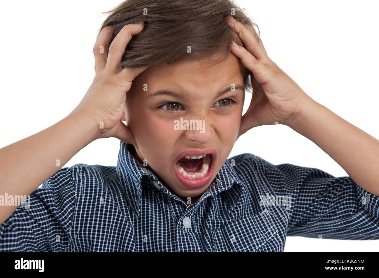Frustrated boy standing against white background Stock Photo - Alamy