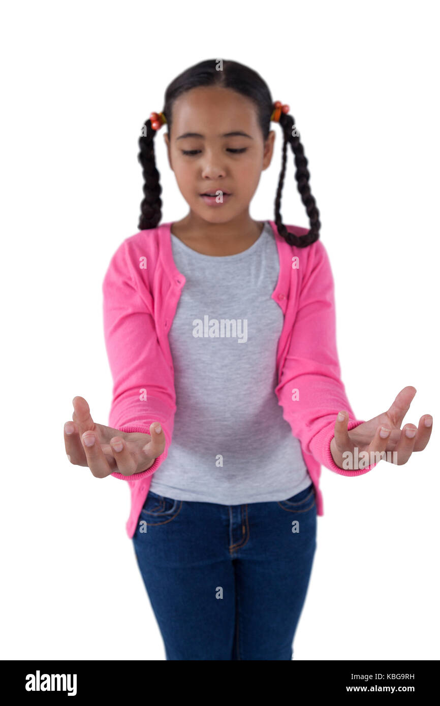 Girl pretending to hold an invisible object against white background ...