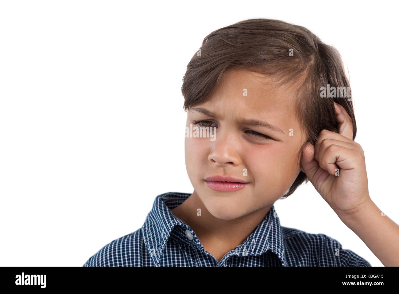 Thoughtful boy standing against white background Stock Photo - Alamy