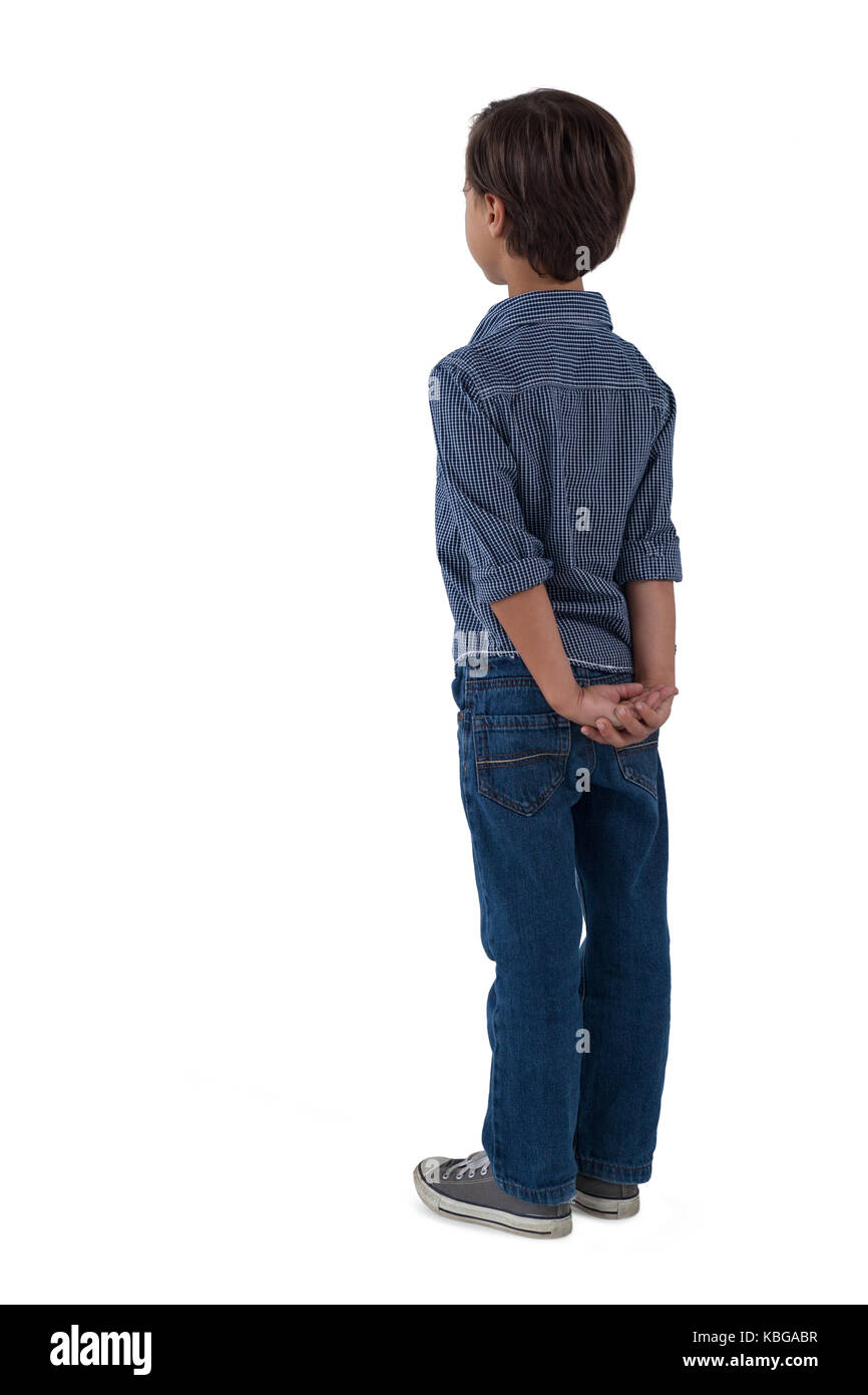 Thoughtful boy standing against white background Stock Photo - Alamy
