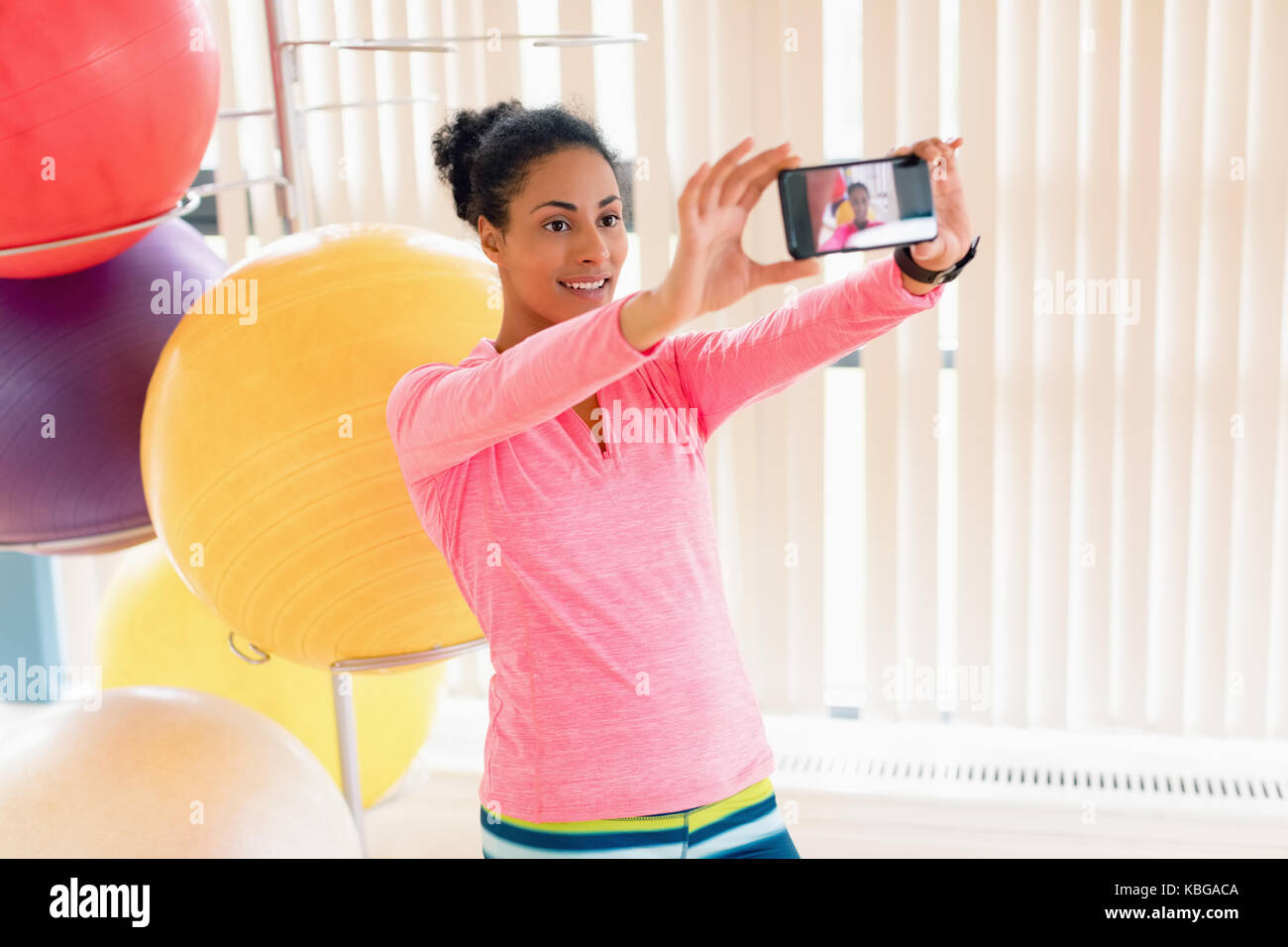 Fit woman photographing mobile phone hi-res stock photography and ...