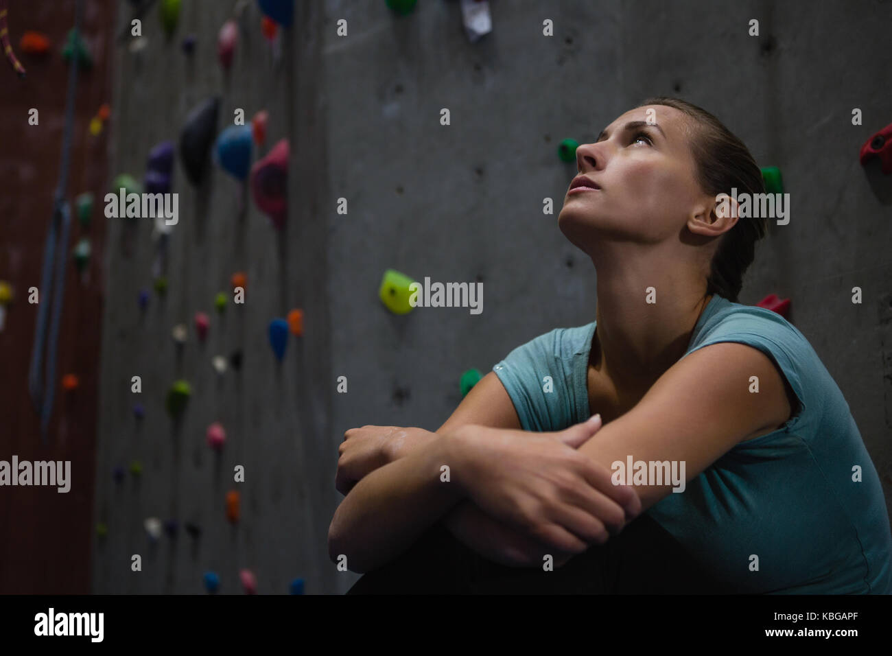 Close up of thoughtful athlete looking up while relaxing in health club ...