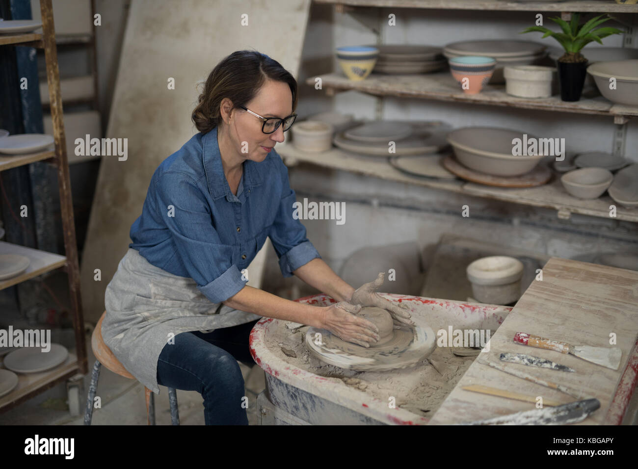 Female potter molding a clay in pottery workshop Stock Photo - Alamy