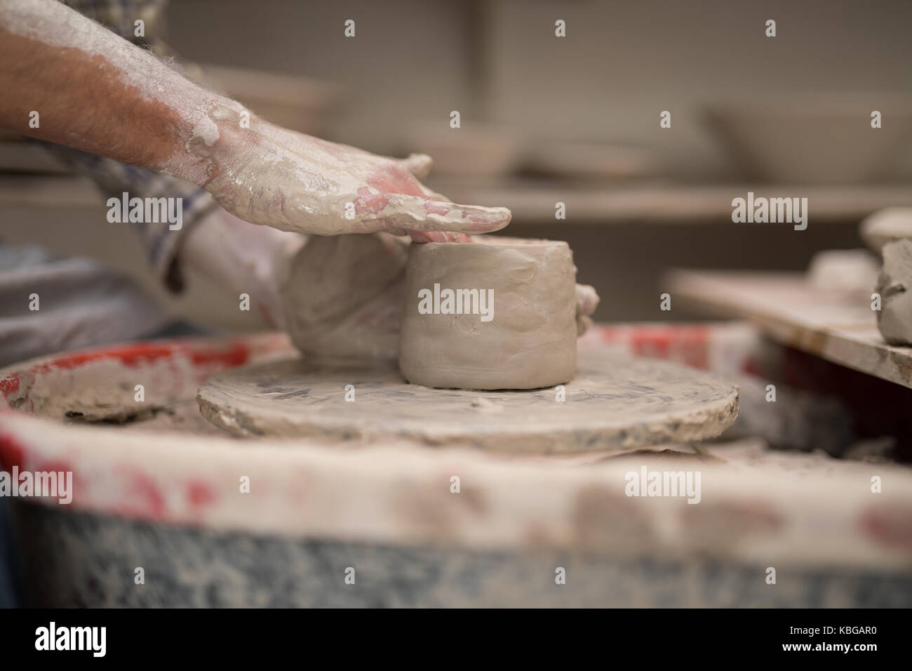 Close-up of male potter molding a clay in pottery workshop Stock Photo ...
