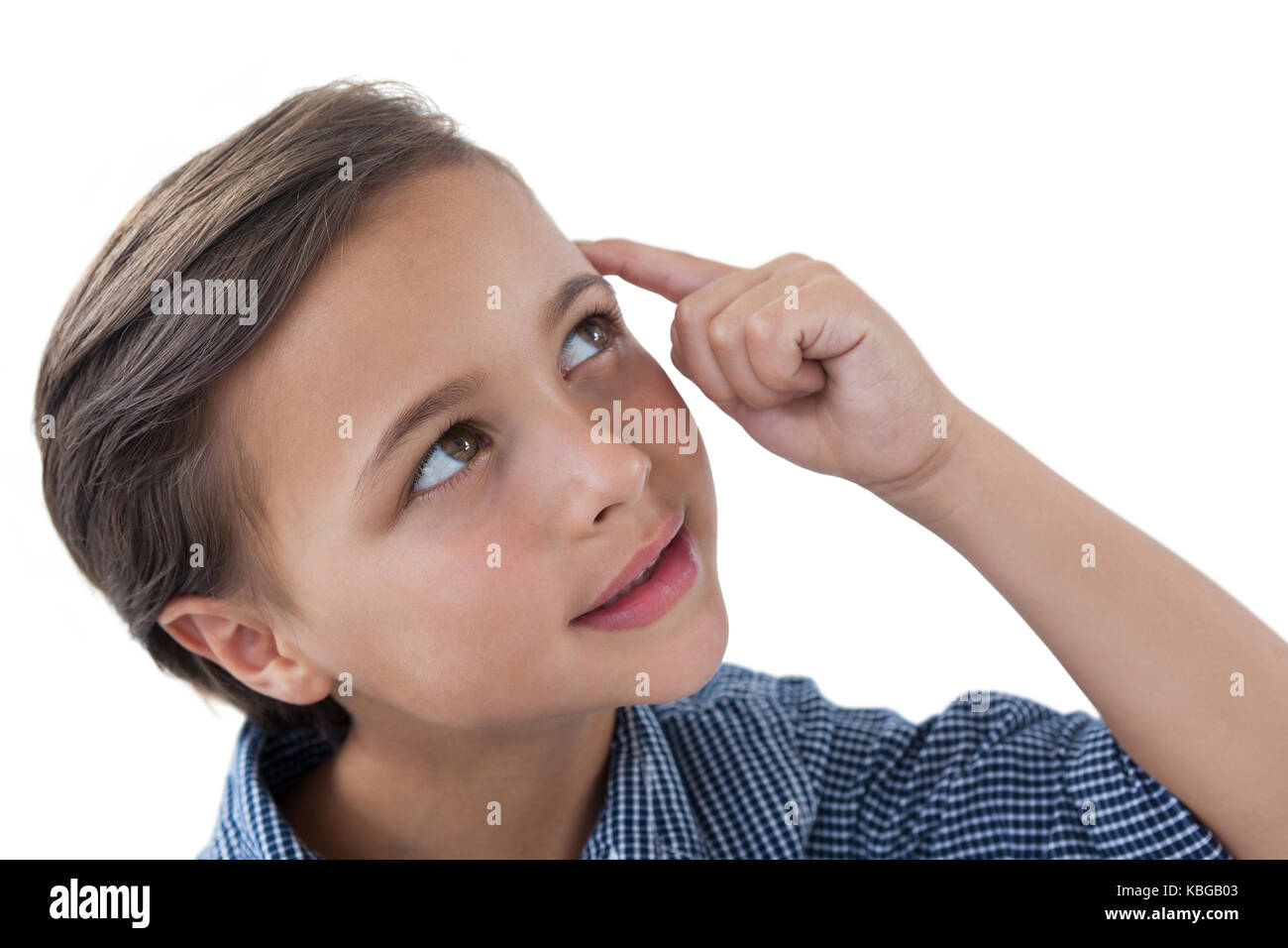 Thoughtful boy standing against white background Stock Photo - Alamy