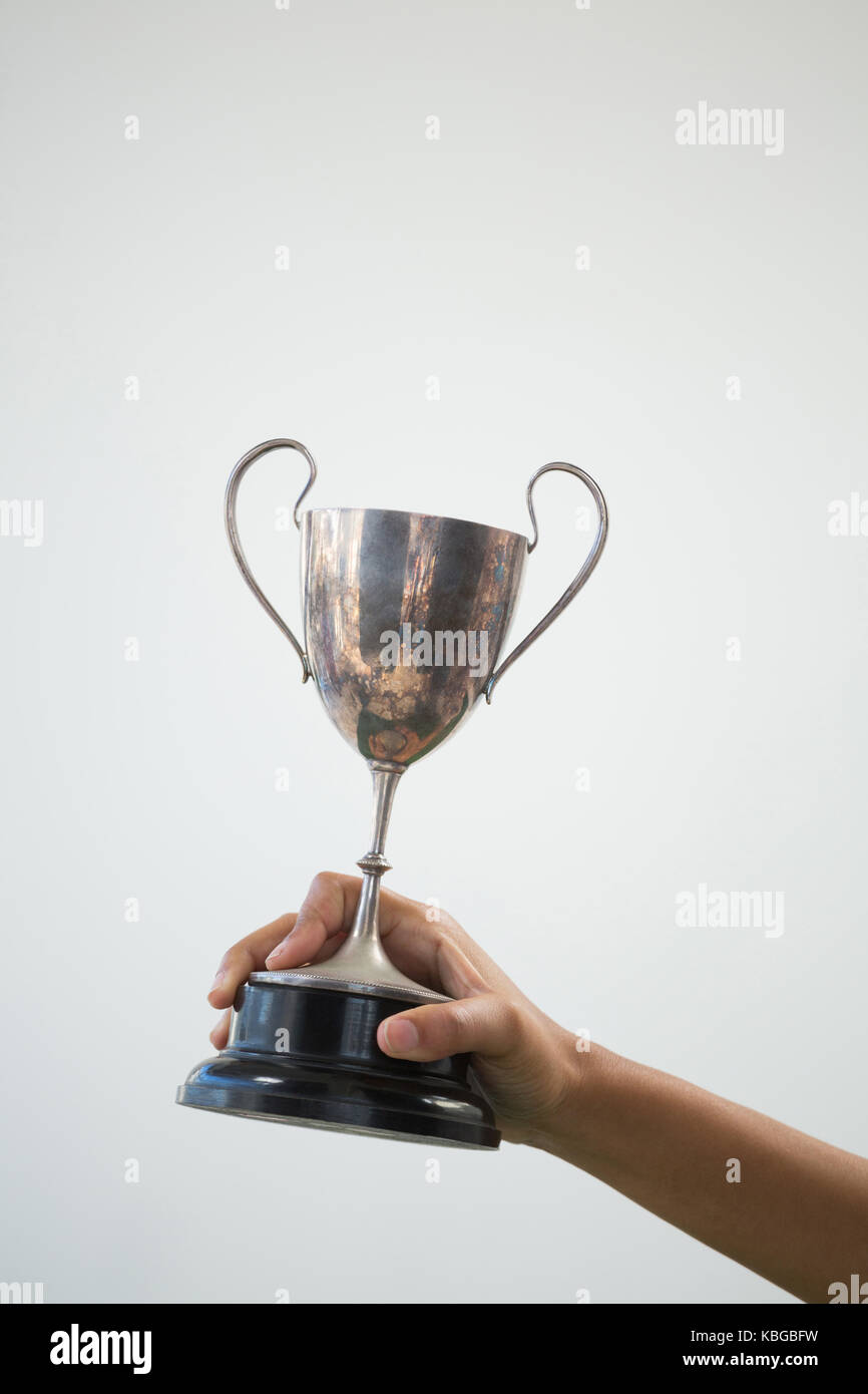 Close-up of hand holding a trophy against white background Stock Photo ...
