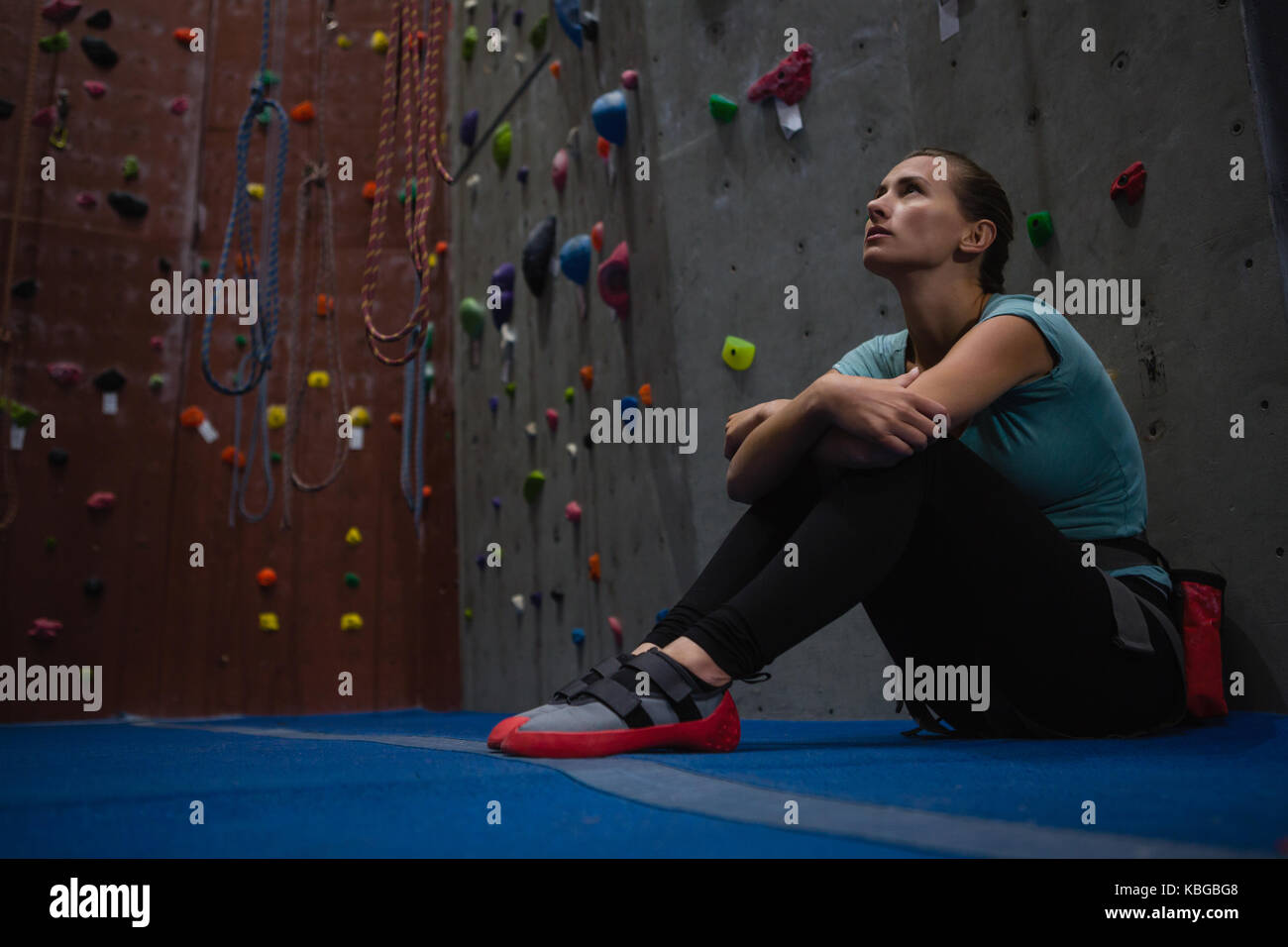 Thoughtful athlete looking up while relaxing in health club Stock Photo ...