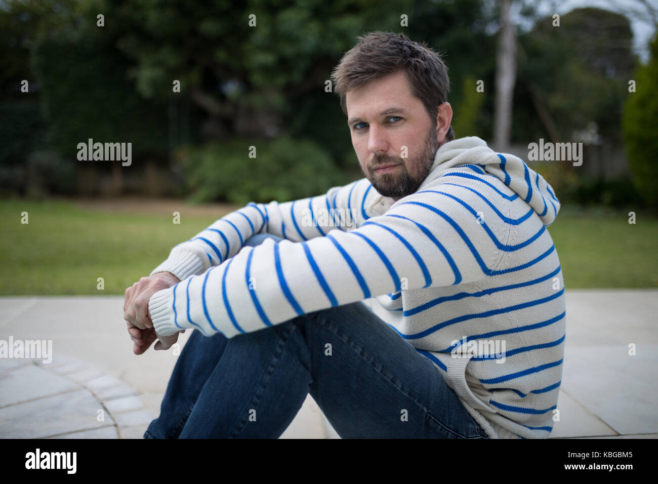 Portrait of man standing in the park Stock Photo - Alamy