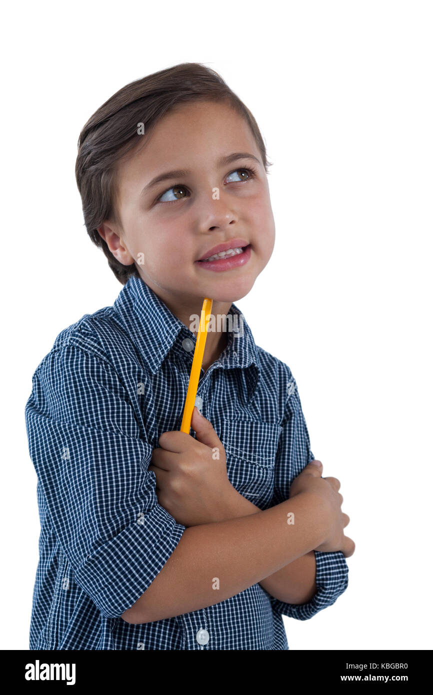 Thoughtful boy standing against white background Stock Photo - Alamy