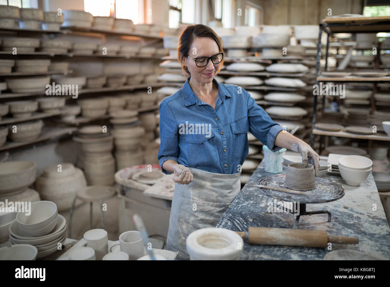 Female potter molding a clay in pottery workshop Stock Photo - Alamy
