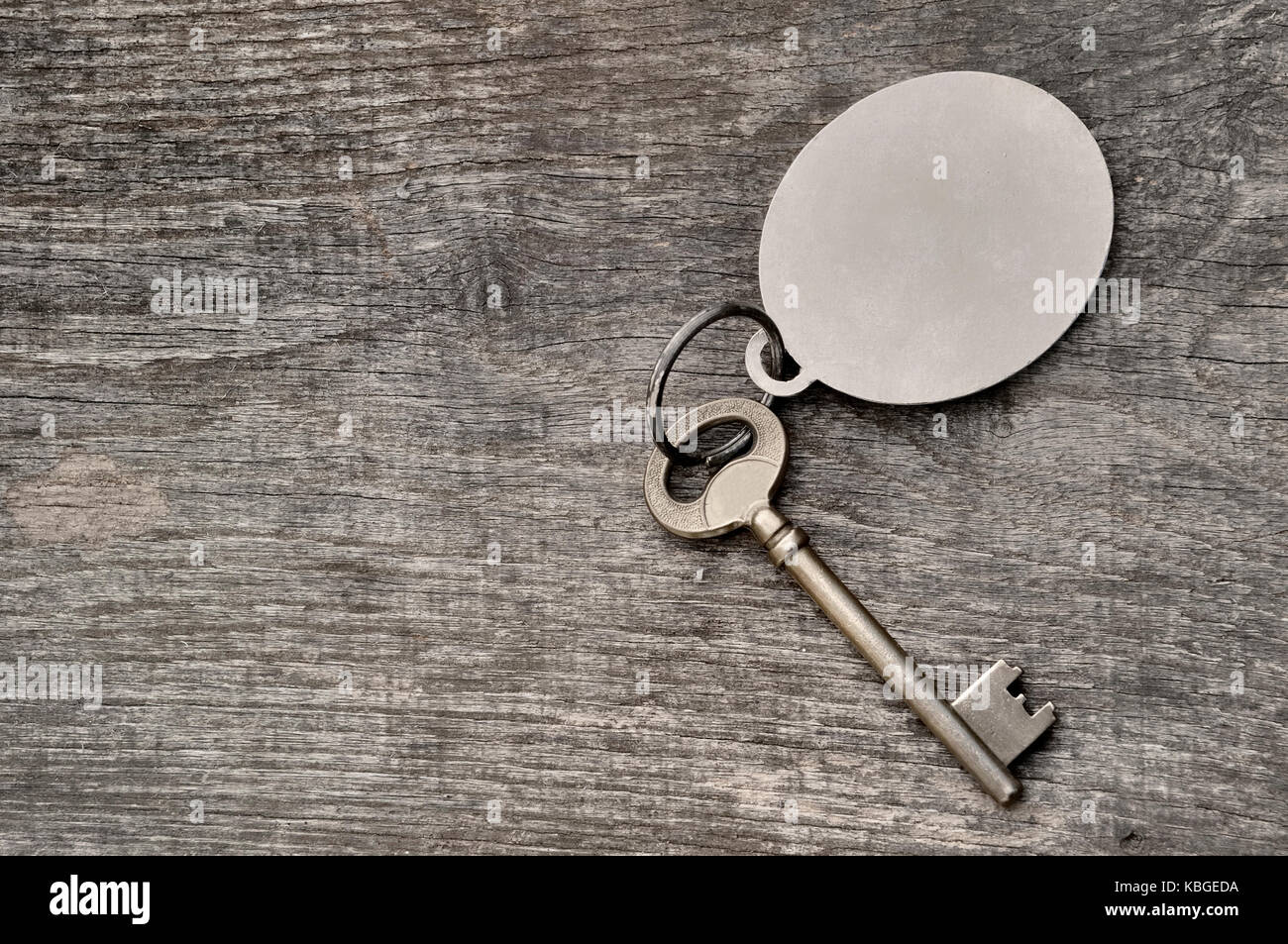 old key on a ring on wooden background Stock Photo - Alamy