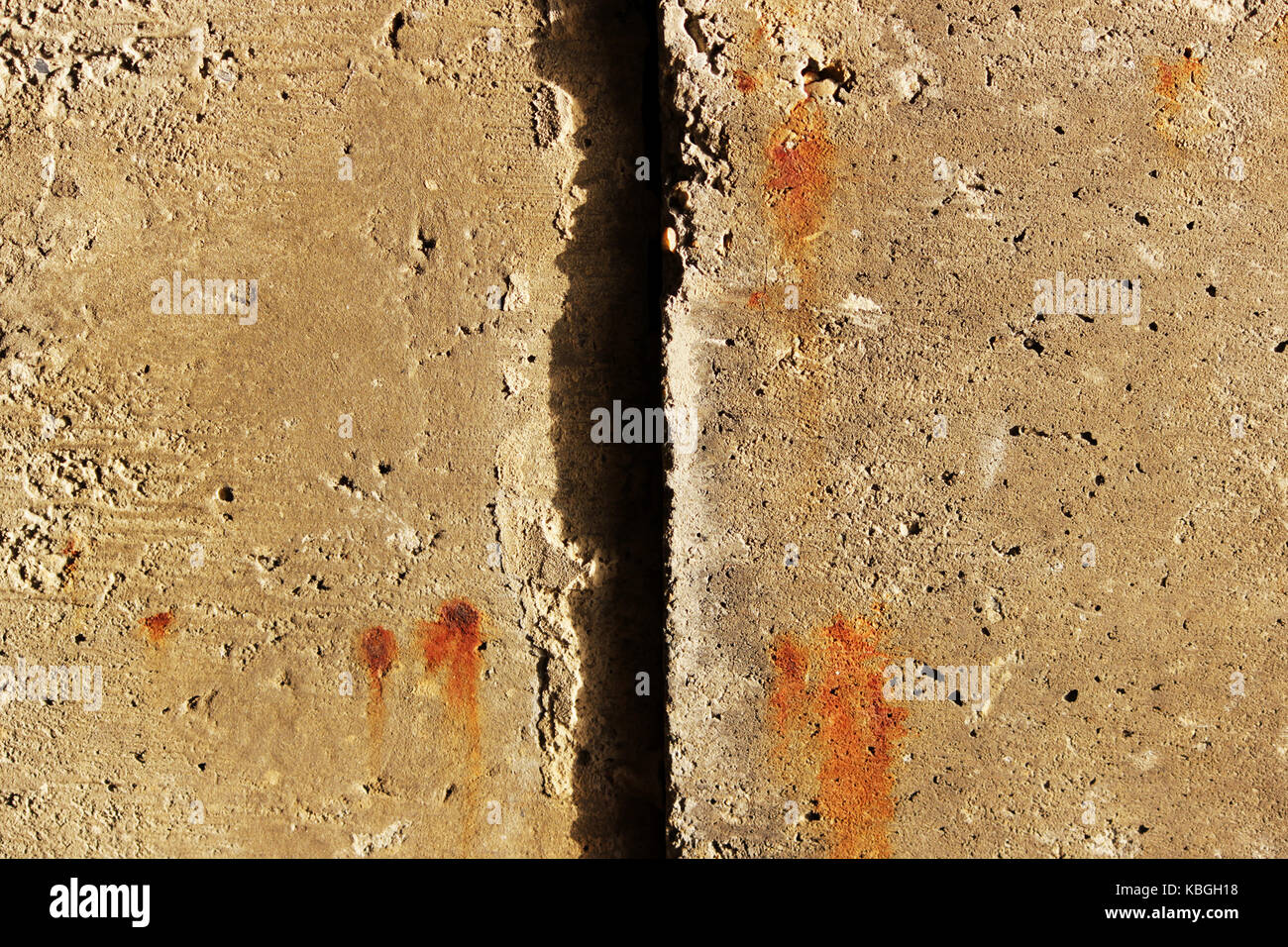 The gap between two docked concrete slabs. traces of rust on a gray ...