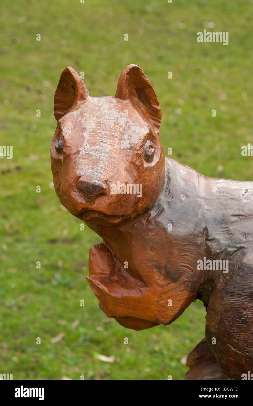 Portrait, close-up shot of grumpy-looking squirrel wood carving, facing ...