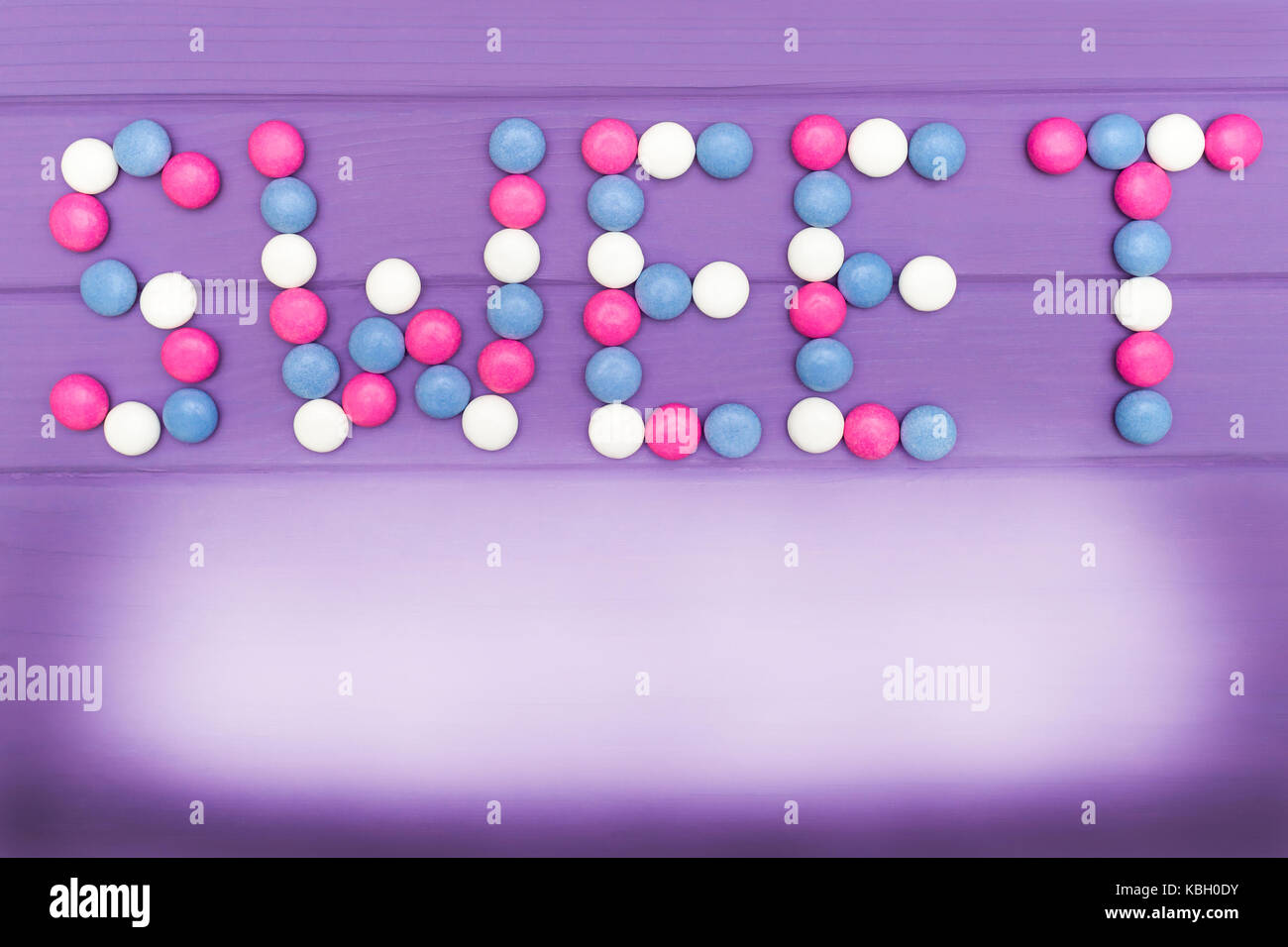 Image of word Sweet made of colorful candies on violet background ...