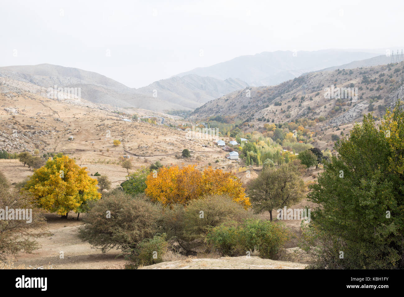 Uzbekistan, mountain landscape. Zaravshan range in misty haze in autumn ...
