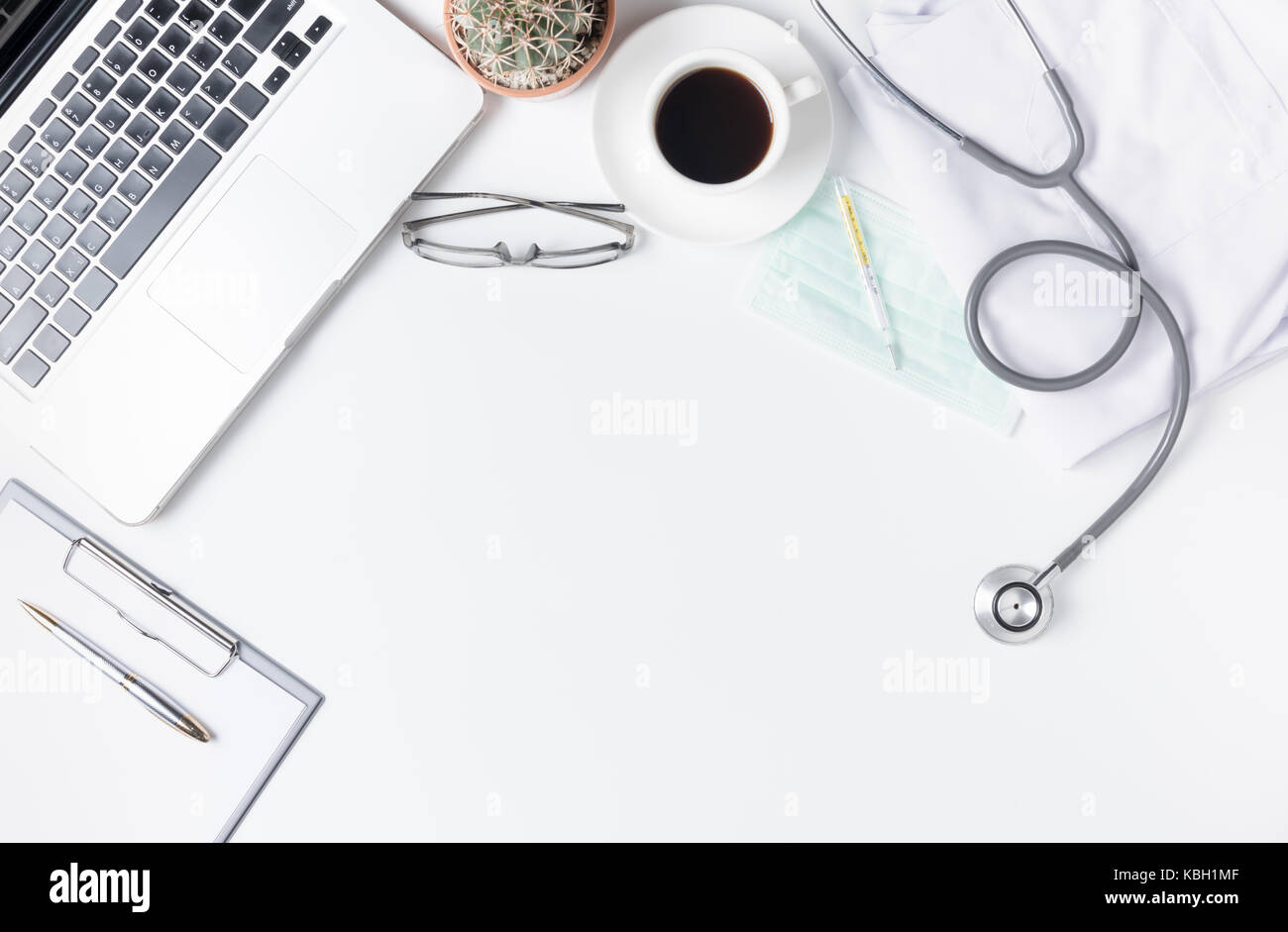Top view of doctor desk table with stethoscope, coffee, Medical gown ...